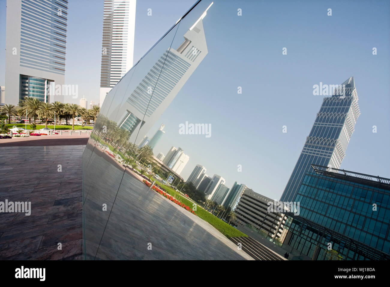 UAE, Dubai, reflection in a mirrored piece of artwork on display at the ...