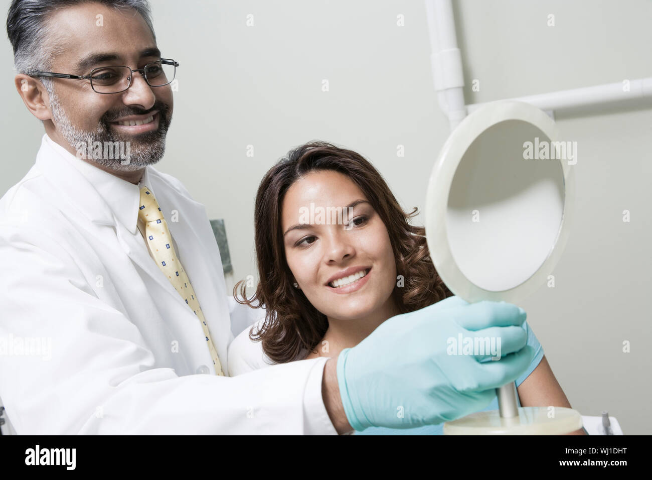 Dentist and patient using mirror Stock Photo - Alamy Dentist and patient using mirror Stock Photo - Alamy