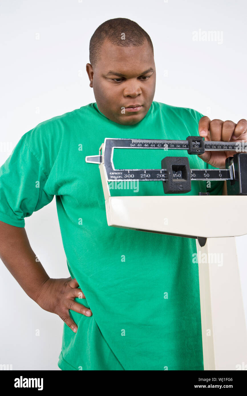 Man using weight scales Stock Photo - Alamy