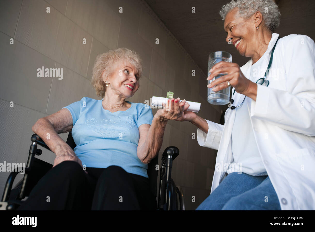 Doctor helping disabled patient Stock Photo - Alamy