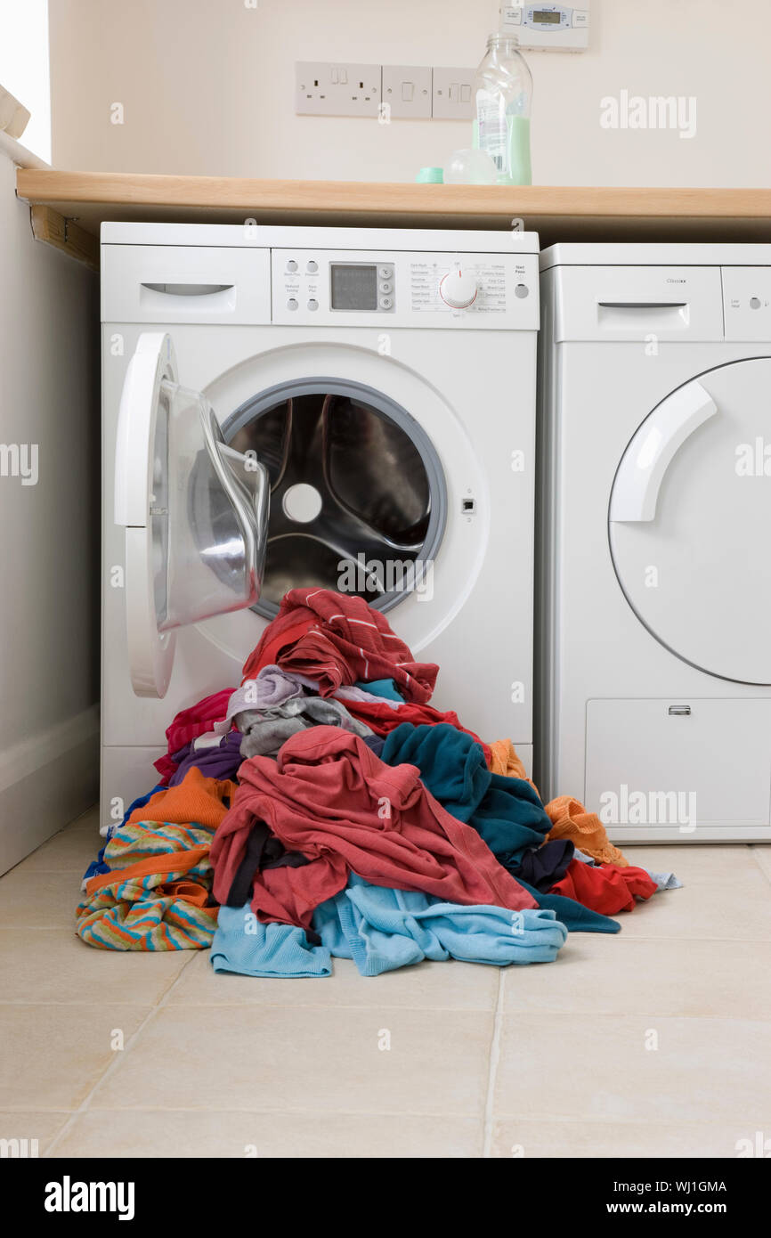 Pile of clothes in front of a washing machine Stock Photo - Alamy