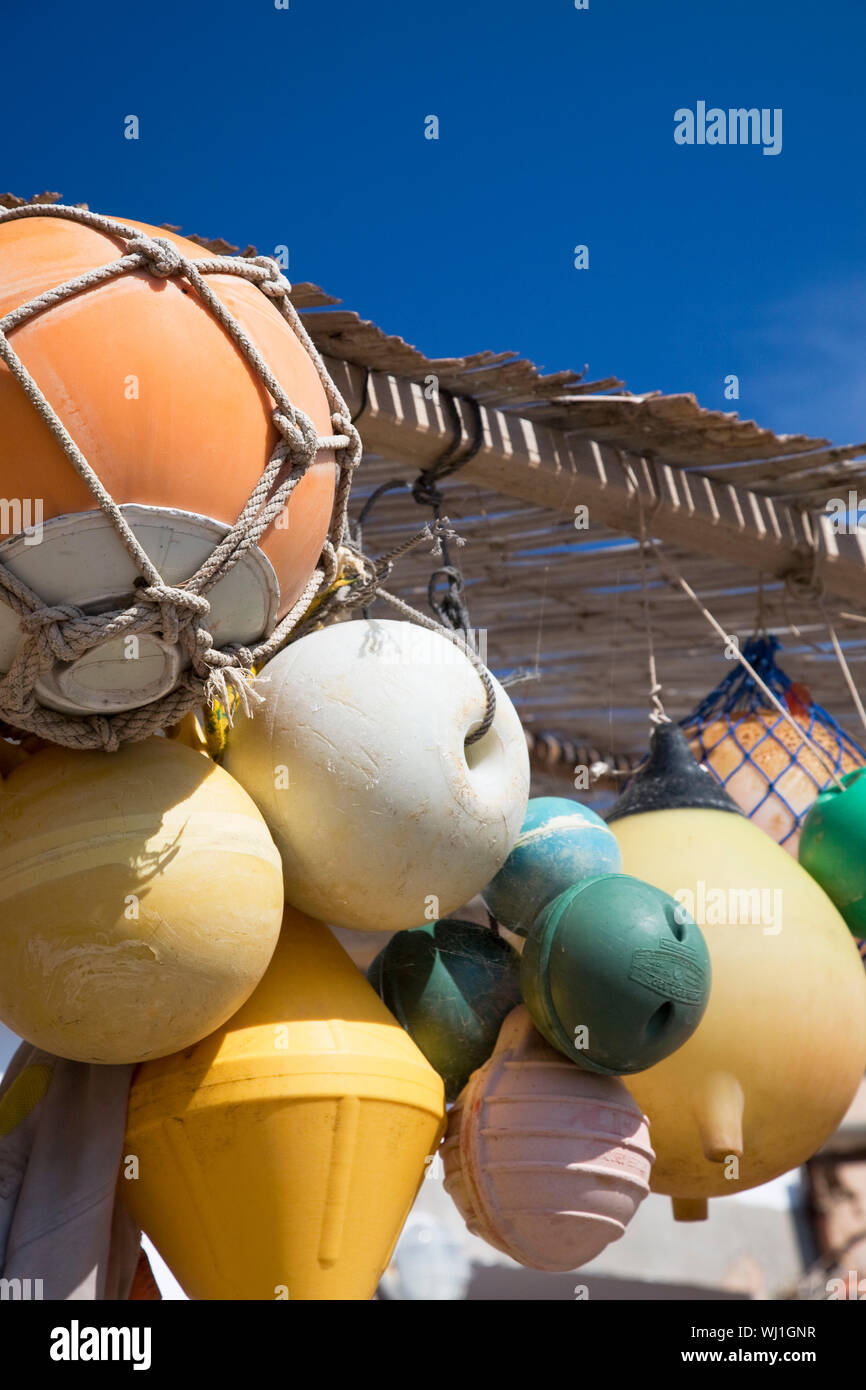 Fishing floats hanging on porch Stock Photo - Alamy