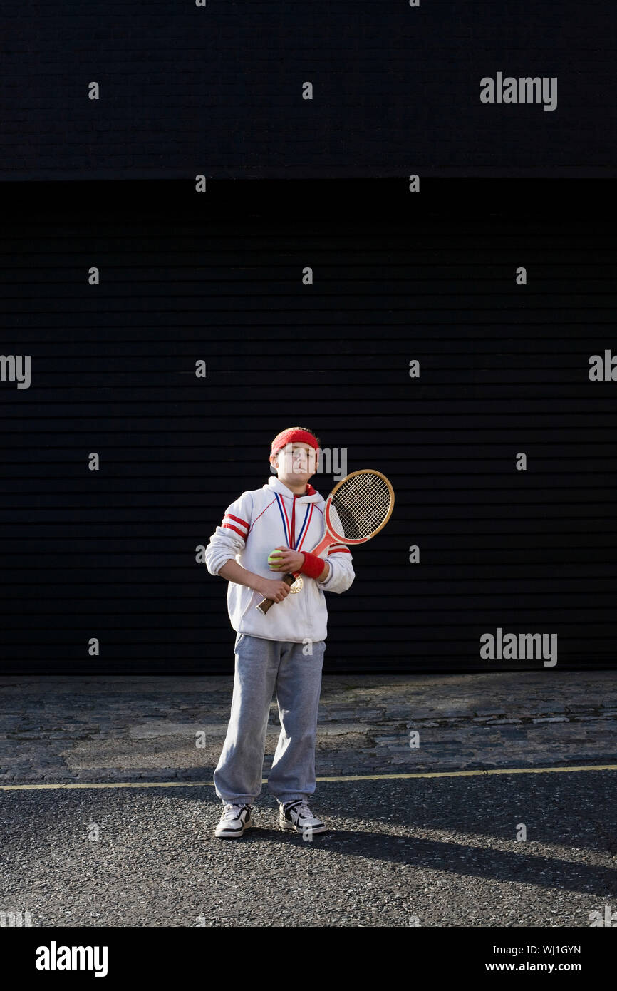 Full length of a young male winner with tennis racket Stock Photo - Alamy