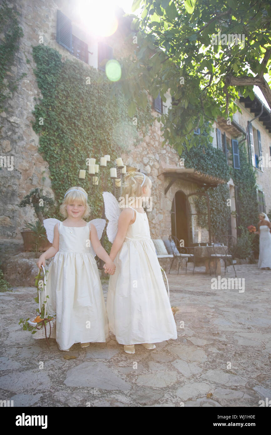 Full length of two young girls wearing wings outdoors Stock Photo - Alamy