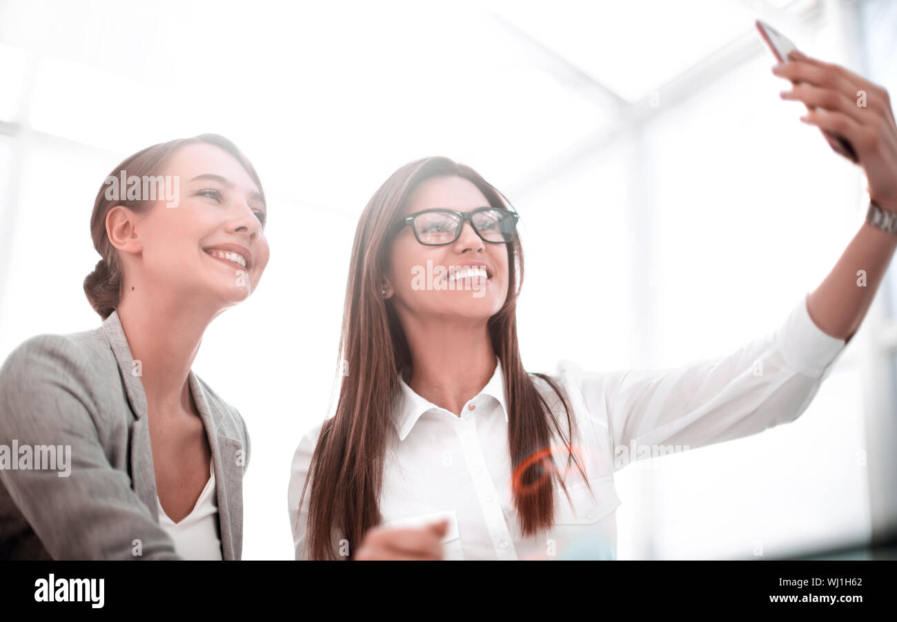 two employees taking a selfie in the workplace Stock Photo - Alamy