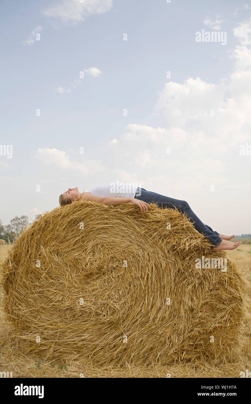 Woman lying in hay hi-res stock photography and images - Alamy