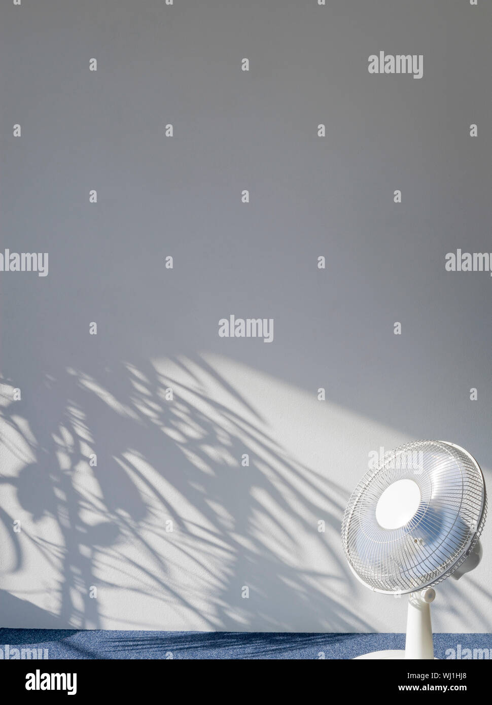 View of an electric fan in empty room Stock Photo - Alamy