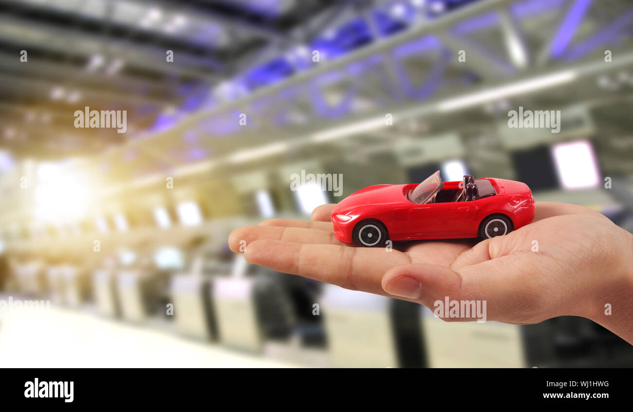 Red toy car in hand Protecting the security concept Stock Photo - Alamy