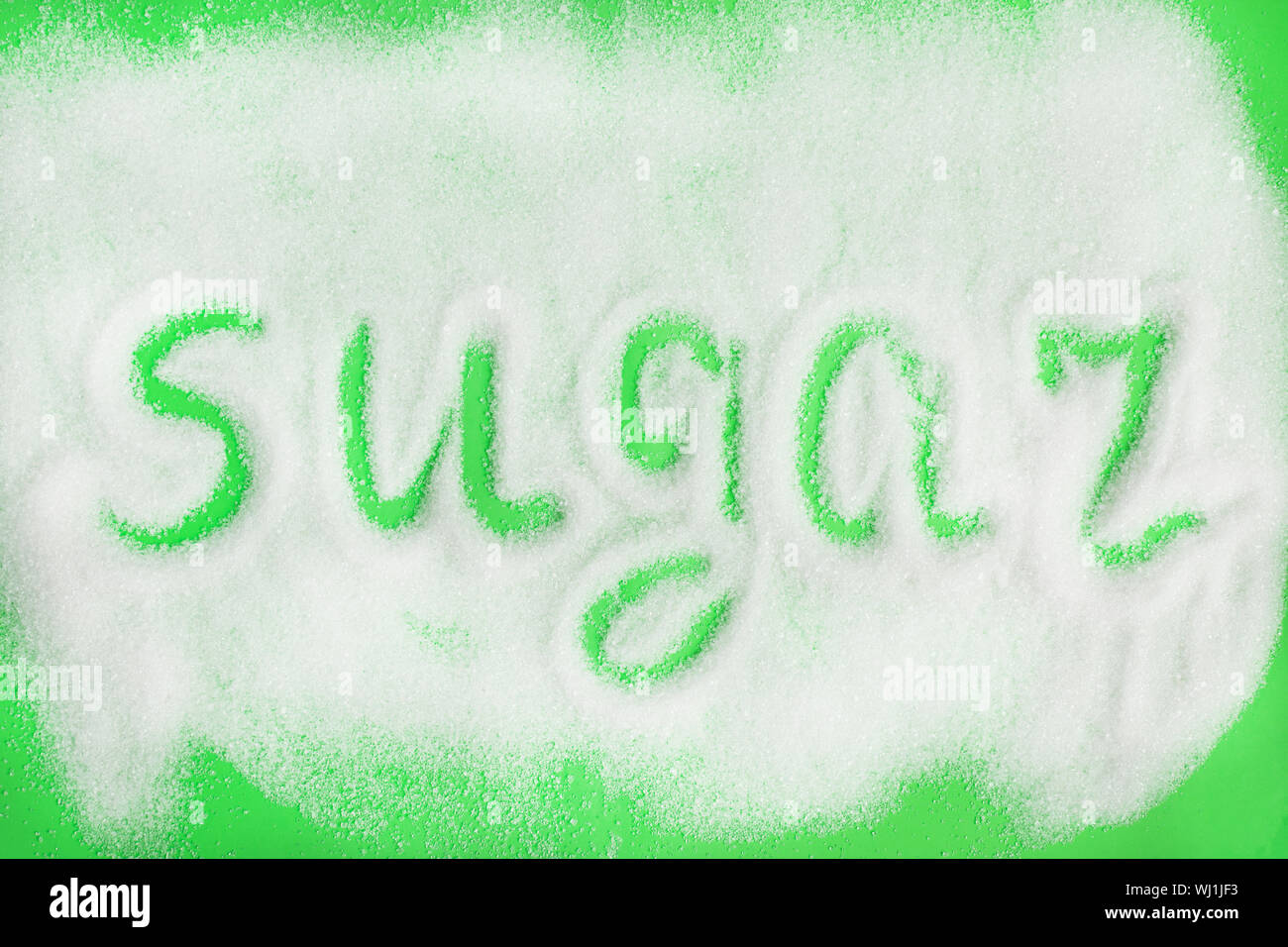 Sugar letters on green background. Word sugar is written on sugar ...