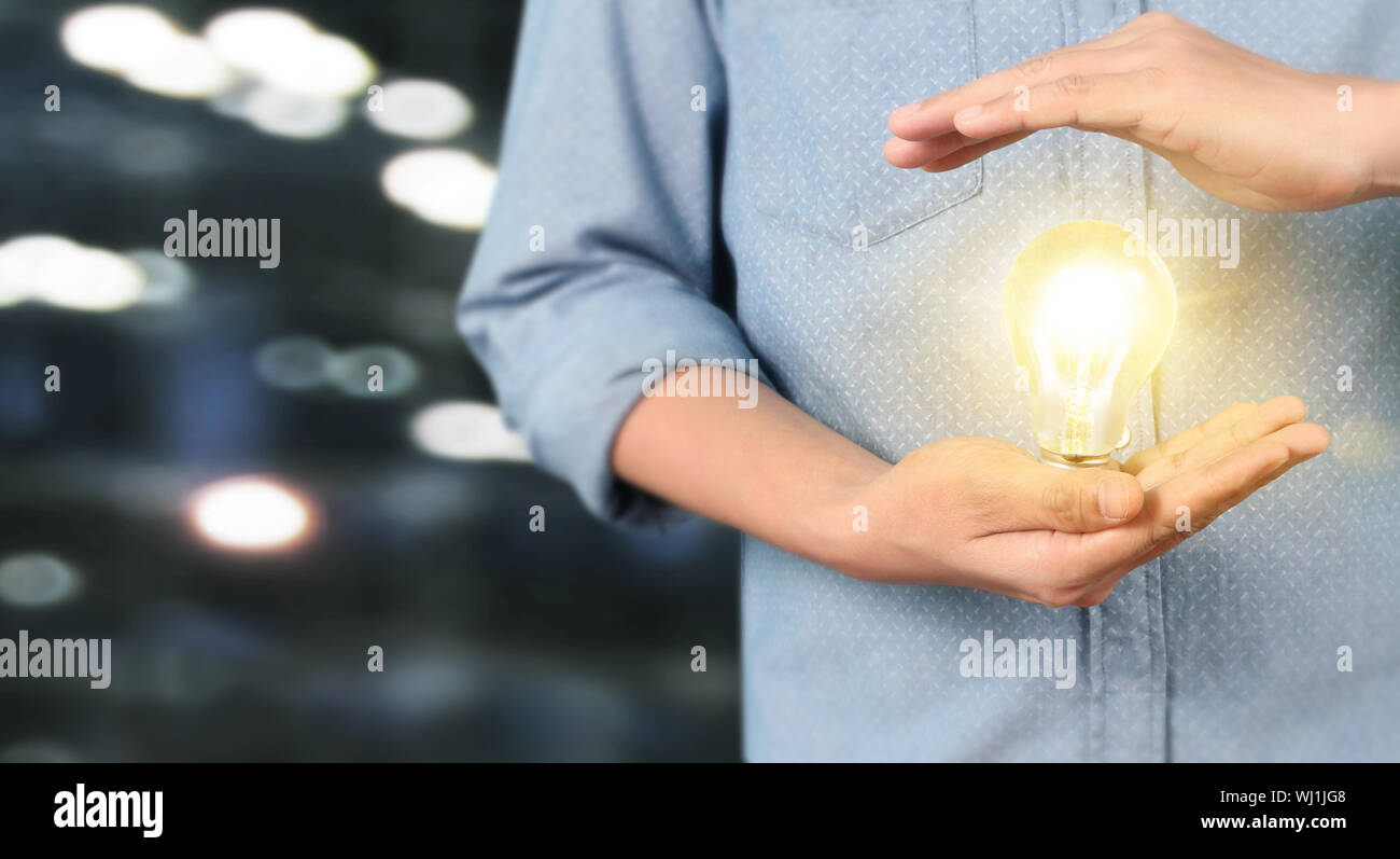 Hand holding illuminated light bulb, idea, innovation and inspiration concept Stock Photo - Alamy