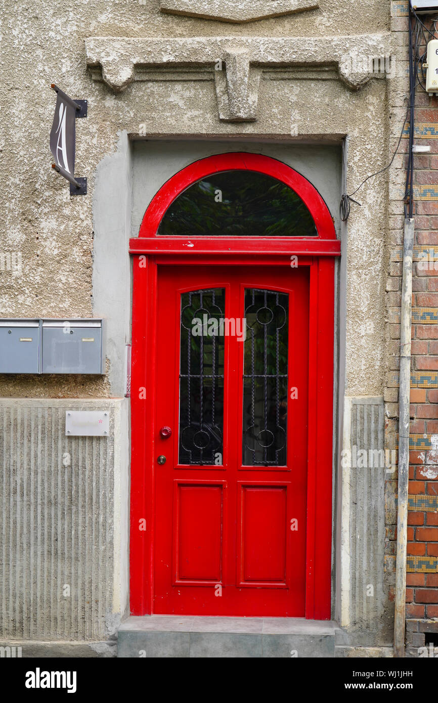 red door in a dilapidated building deterioration, Bucharest Romania ...