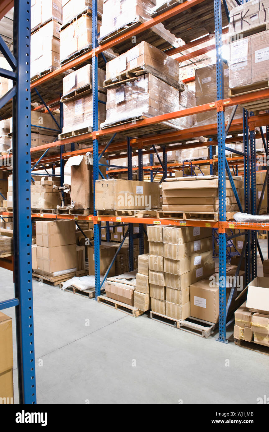 Cardboard boxes on shelves in distribution warehouse Stock Photo - Alamy