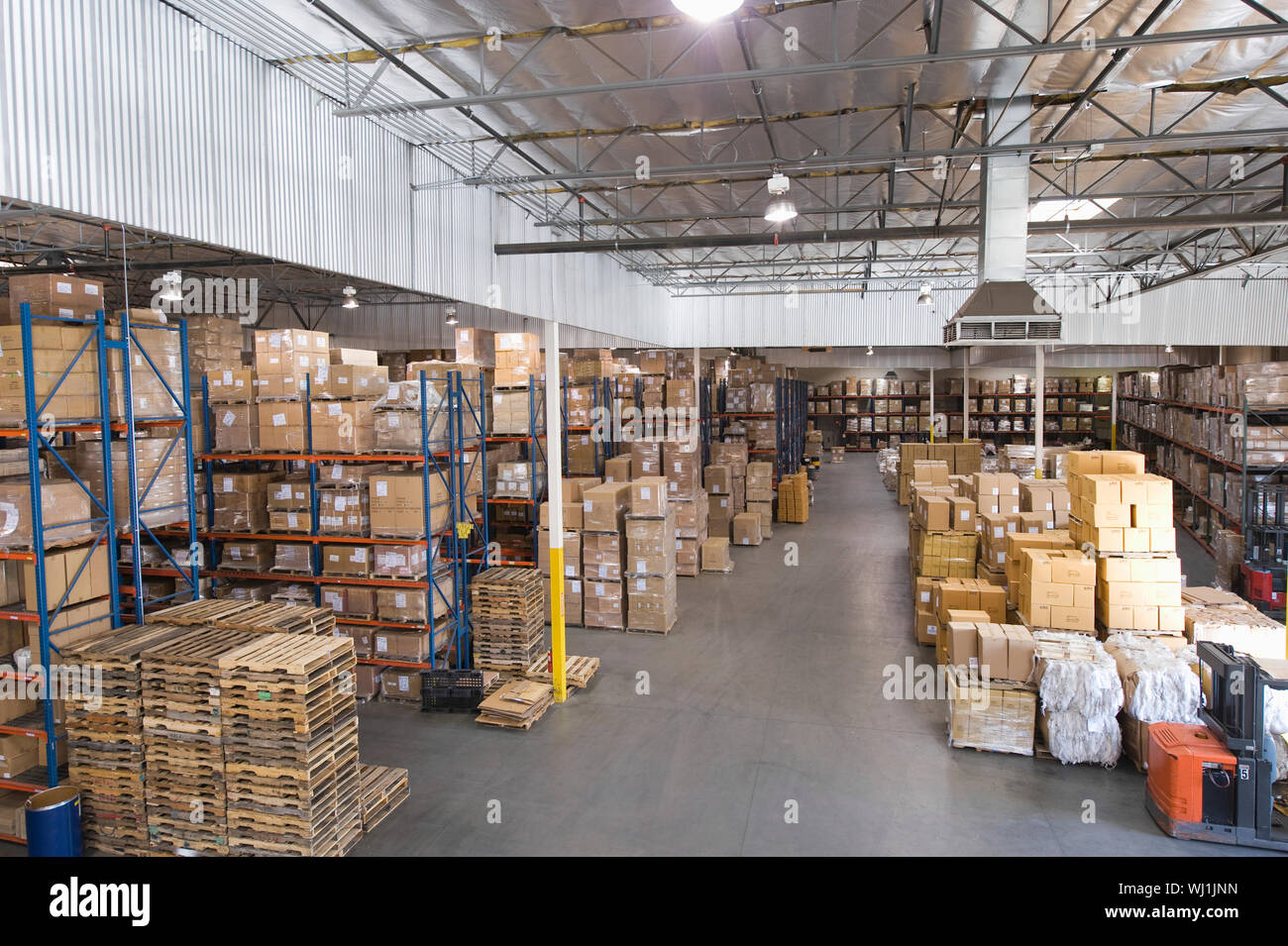 Cardboard boxes stacked in distribution warehouse Stock Photo - Alamy