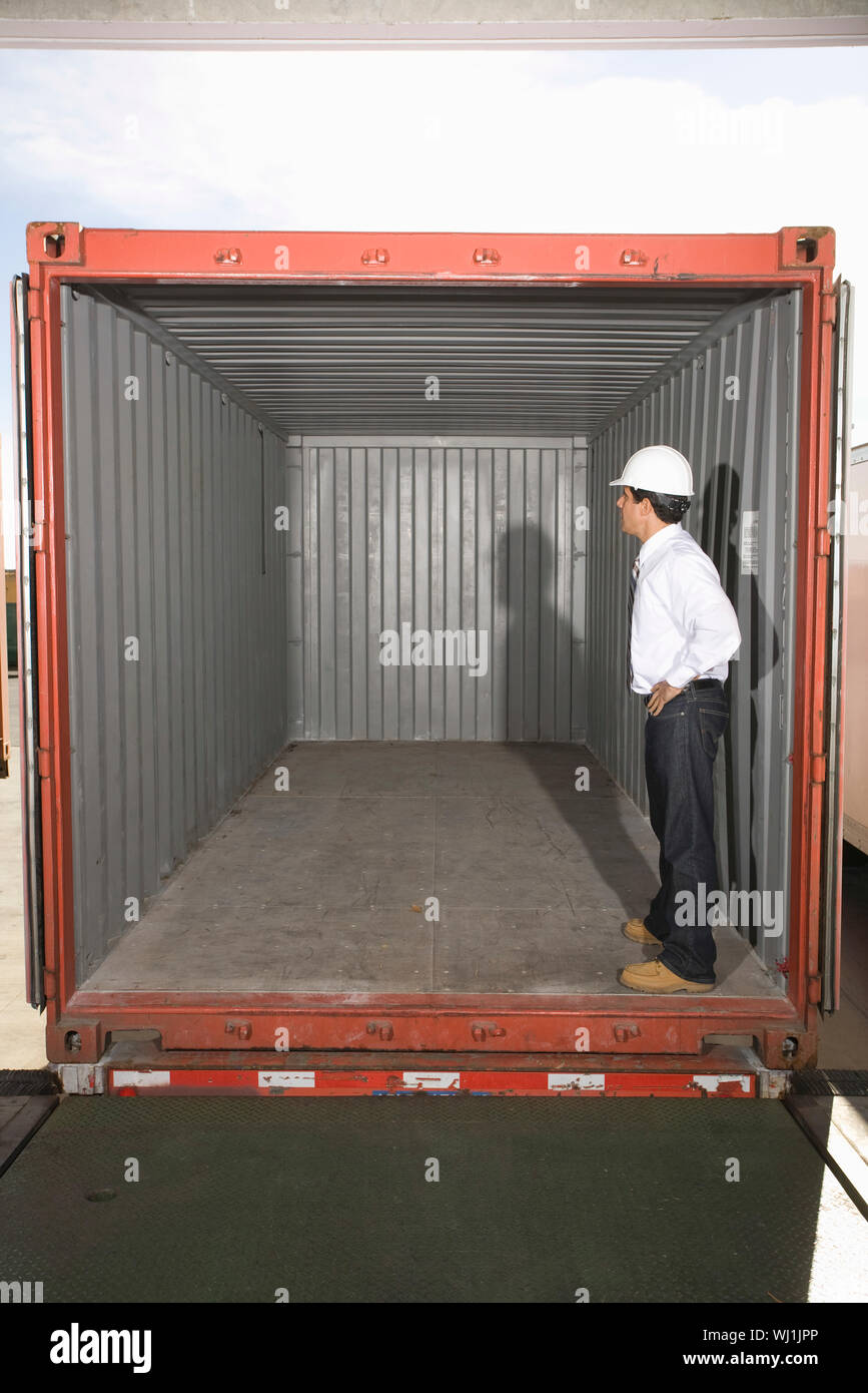 Full length side view of a man standing in empty container Stock Photo ...