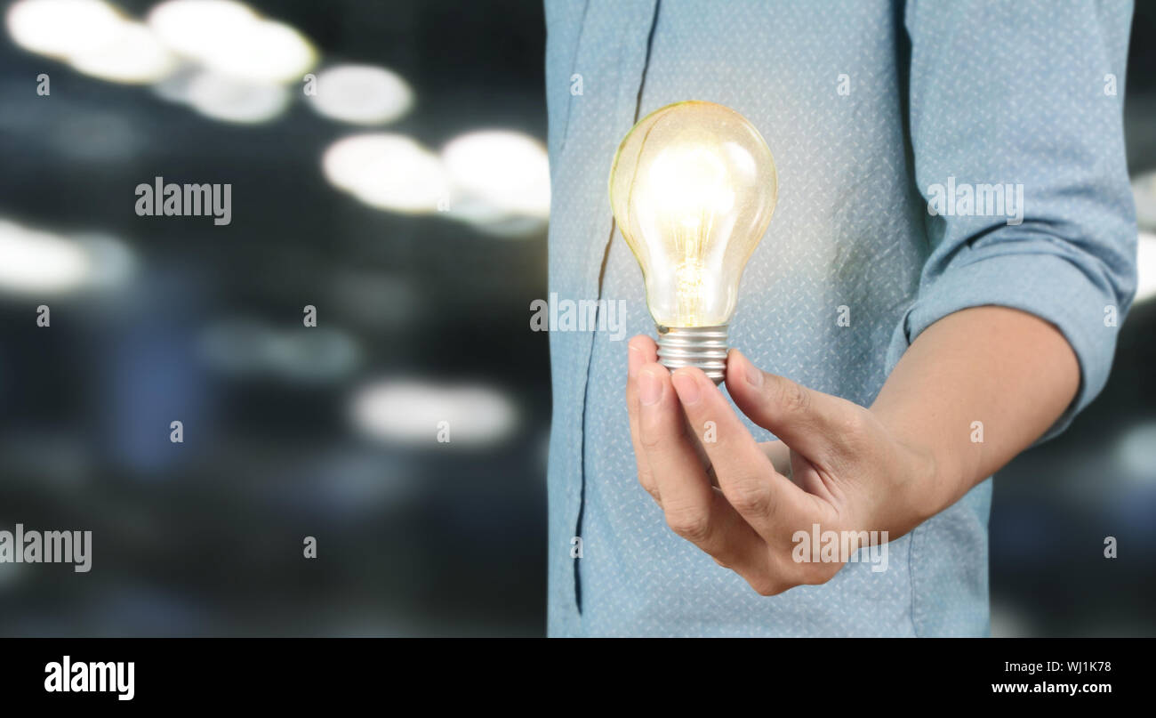 Hand holding illuminated light bulb, idea, innovation and inspiration concept Stock Photo - Alamy