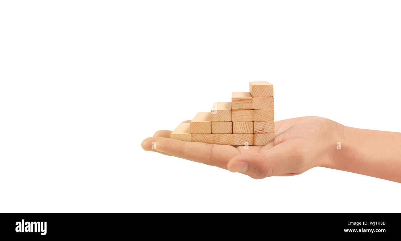 Wood block stacking as step stair with arrow up in a hand. Ladder ...