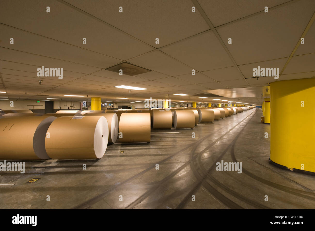 View of huge rolls of paper in spacious newspaper factory Stock Photo ...
