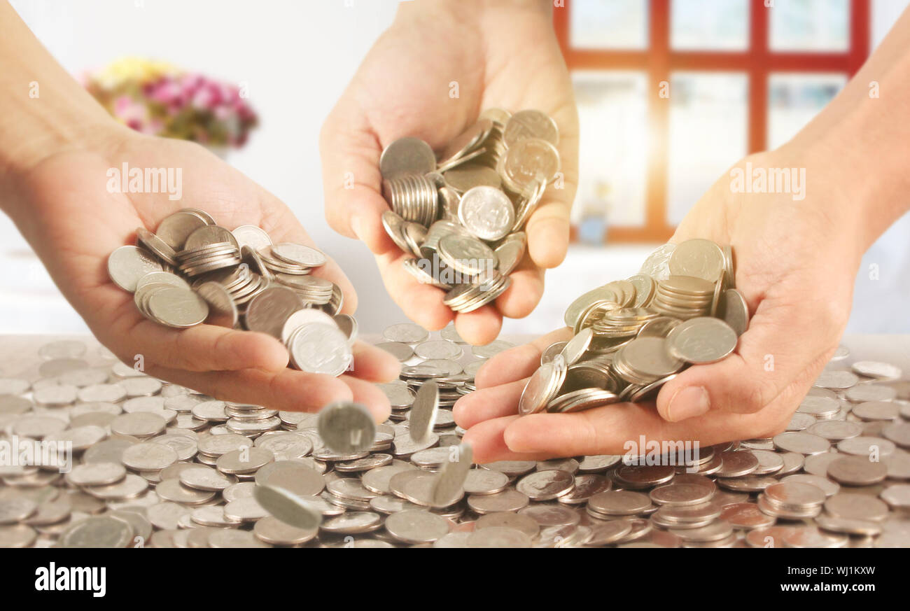 Coins placed on top. While a men's hand pouring coins Stock Photo - Alamy