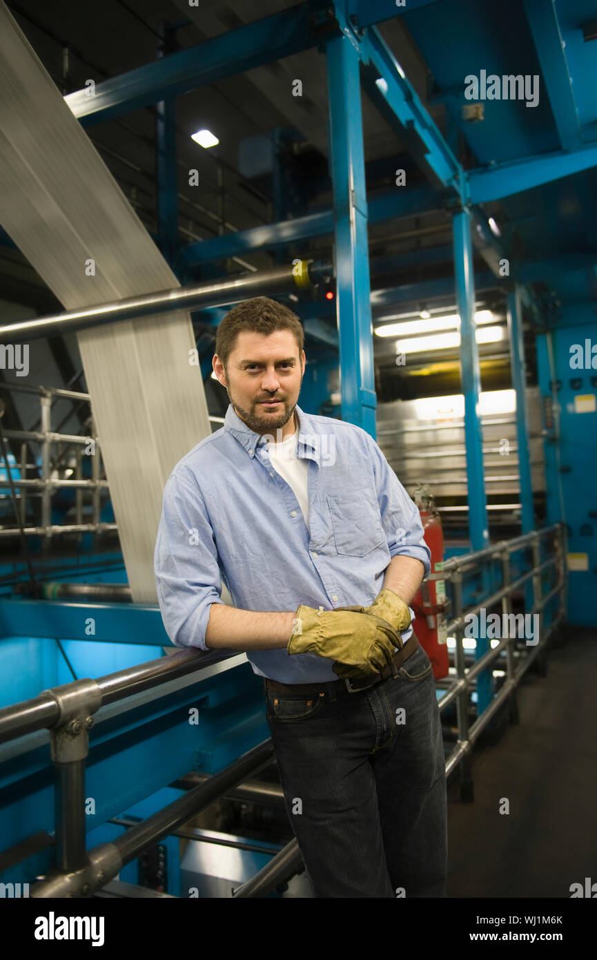 Paper industry manufacturing machinery paper mill standing worker hi ...