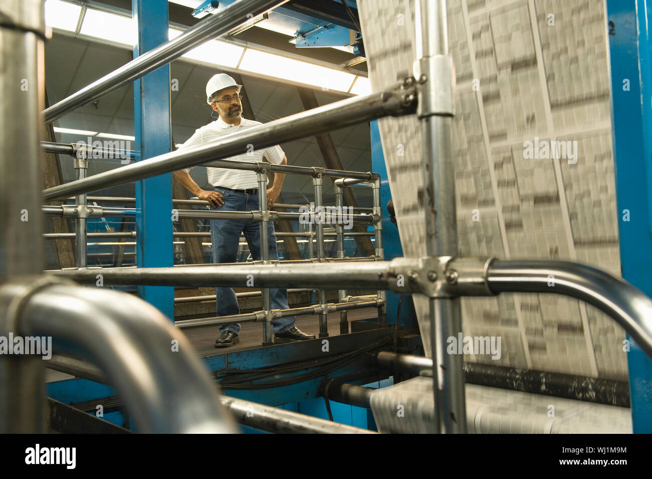 Full length of an Indian man working in newspaper factory Stock Photo ...
