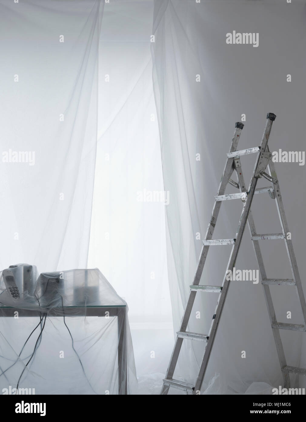 Desk covered in transparent dust sheets in preparation for decoration ...