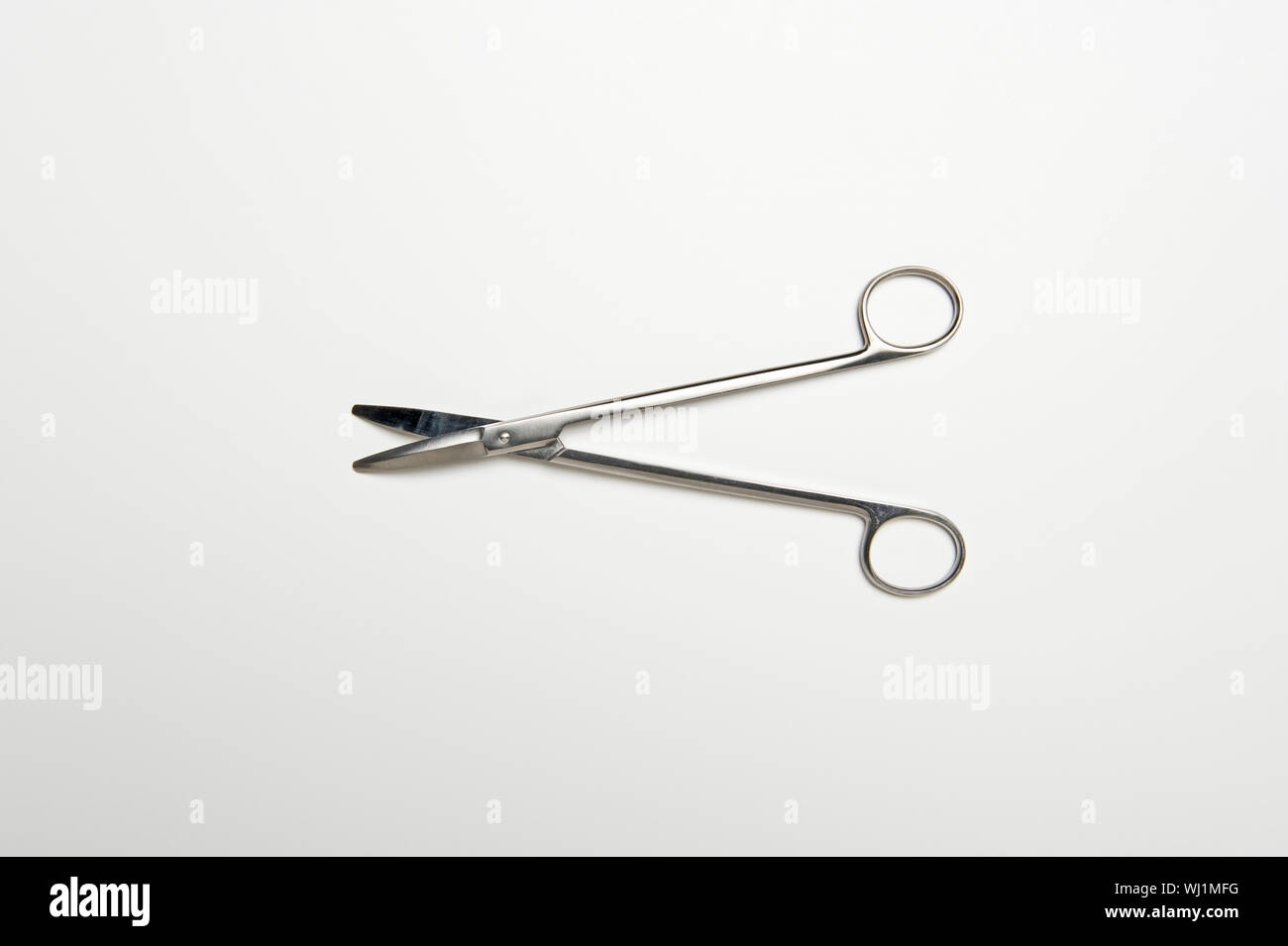 Medical scissor isolated over white background Stock Photo - Alamy