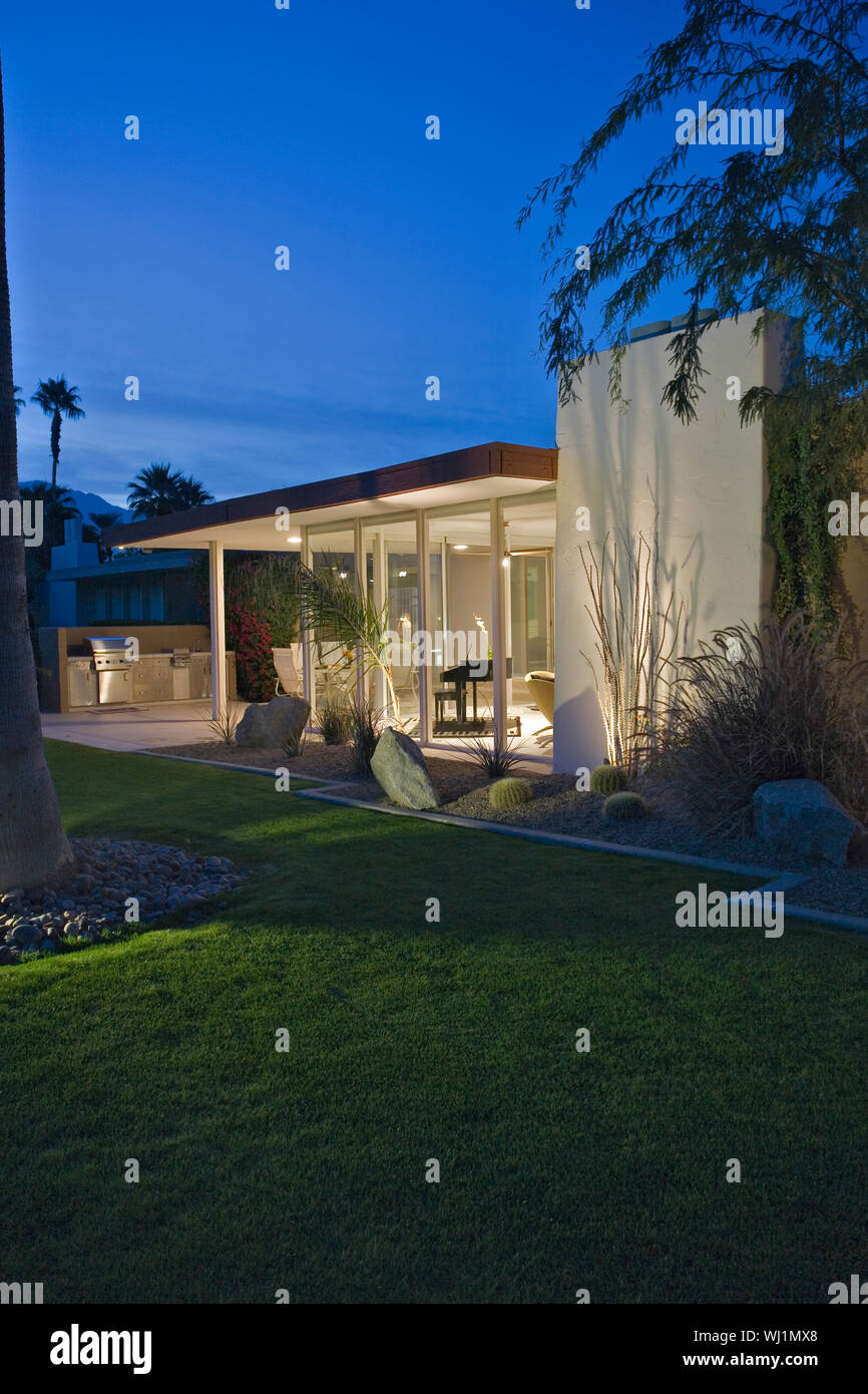 Modern house exterior with lawn in foreground at night Stock Photo - Alamy