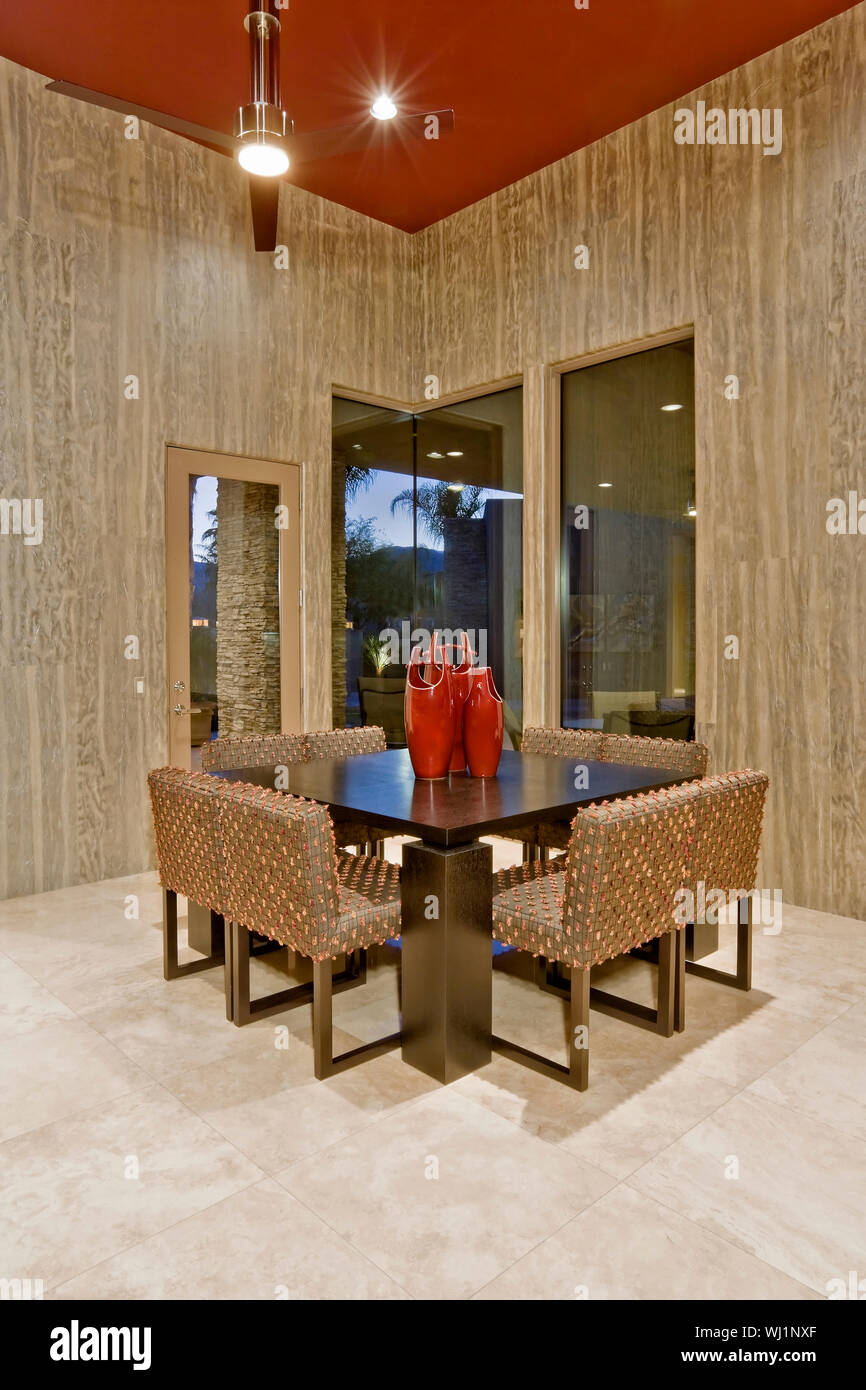 Four chairs with round dining table on tiled floor in modern house ...