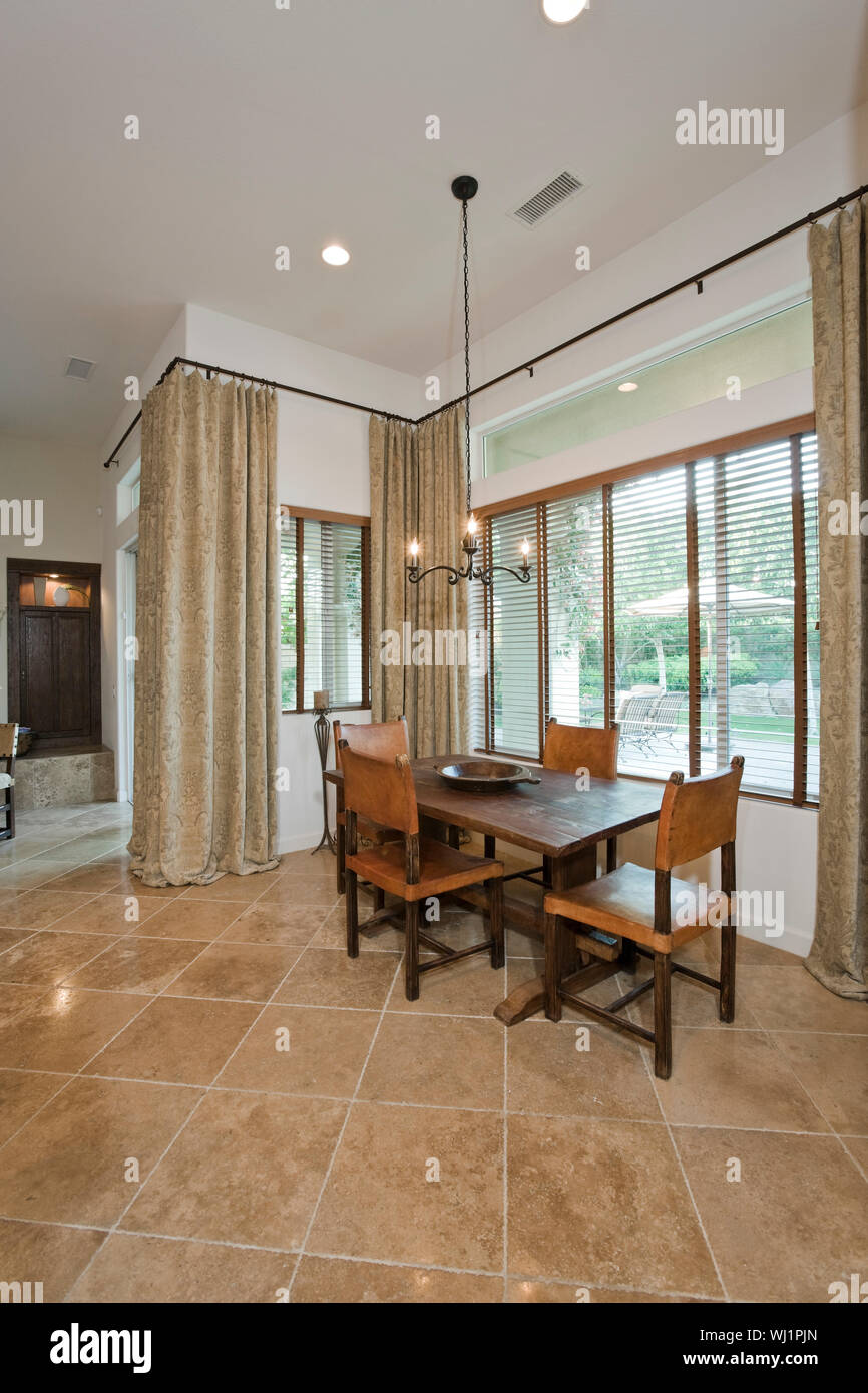 Four chairs with dining table on tiled floor in modern house Stock ...