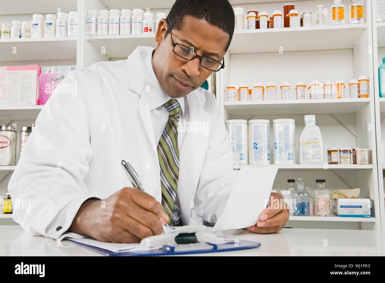 African American male pharmacist working in pharmacy Stock Photo - Alamy