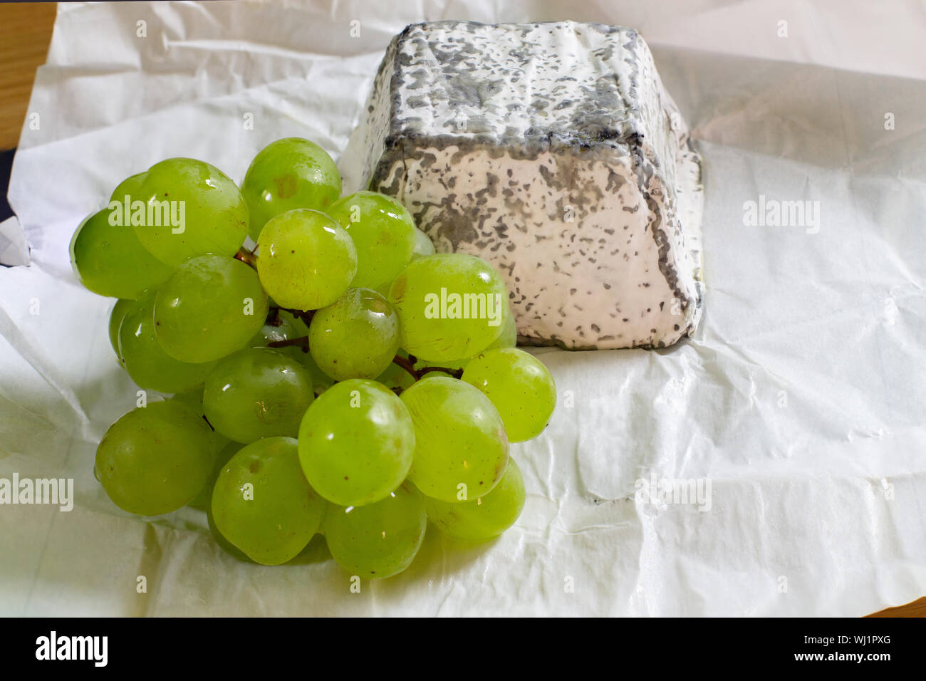 Soft farm cheese made from goat milk with mold and charcoal. Served by ...