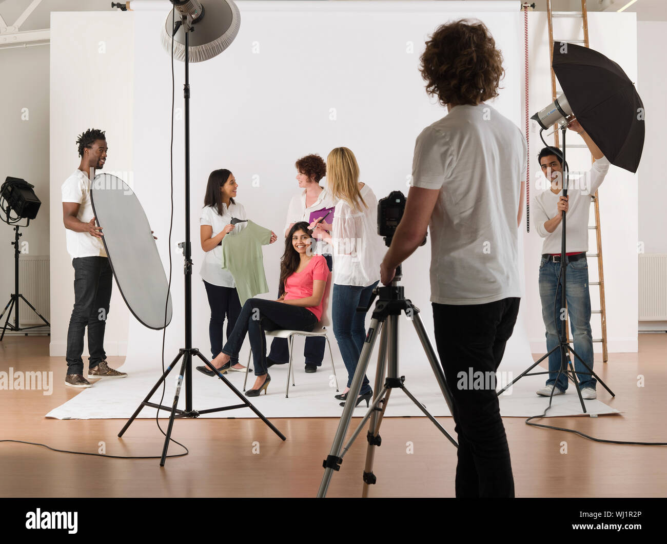 Group of multiethnic young people in studio during photo session Stock ...