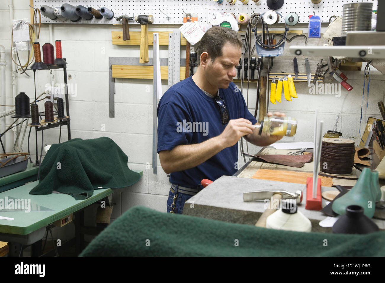 Side view of a male shoemaker at work in traditional workshop Stock ...