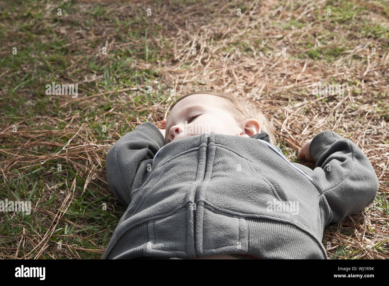 Boy napping on grass hi-res stock photography and images - Alamy