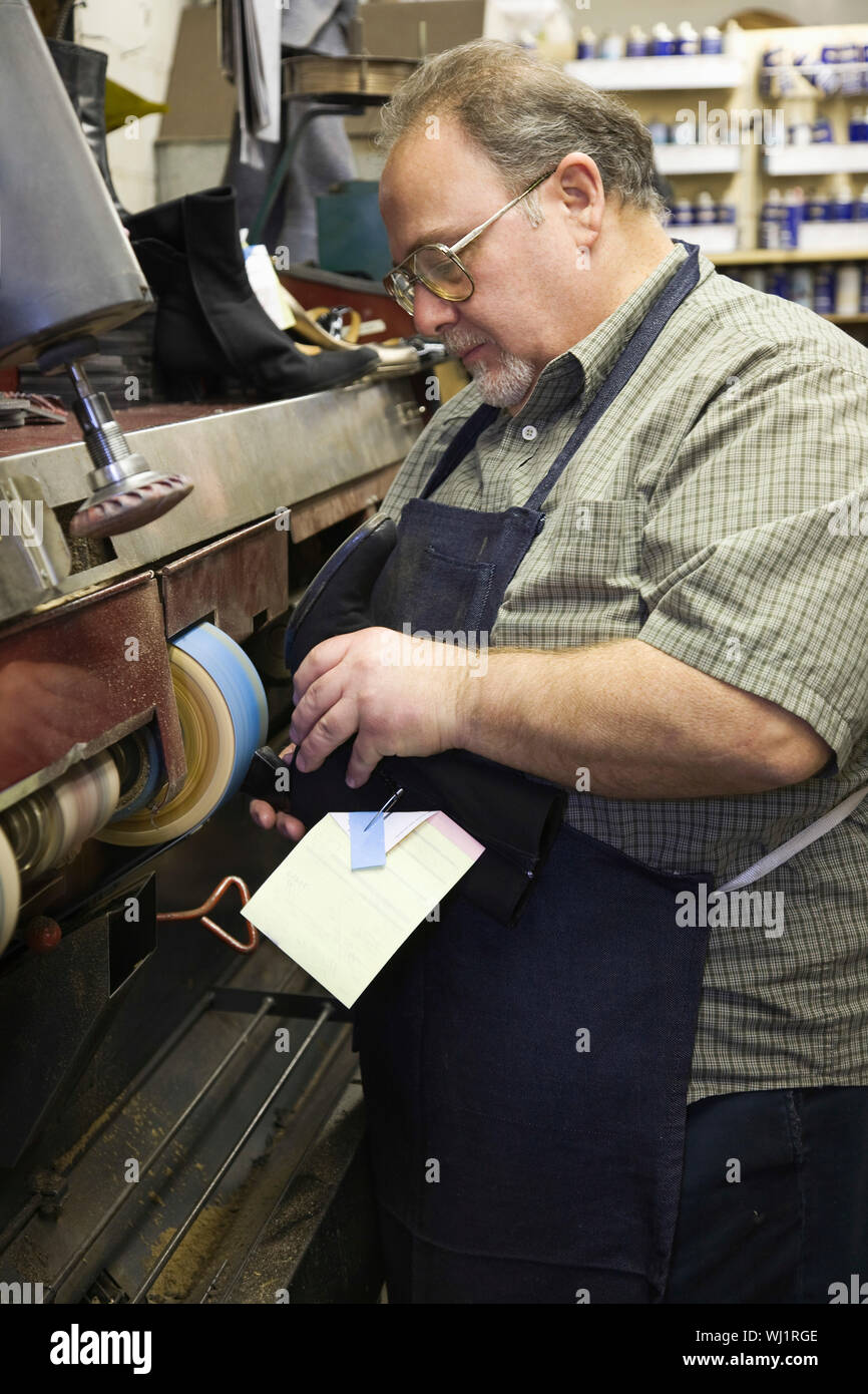 Side view of a male shoemaker at work in traditional workshop Stock ...