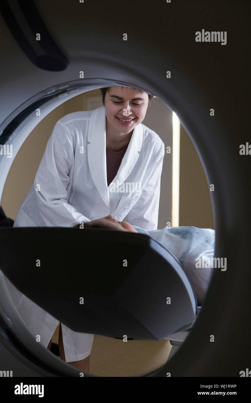Female doctor examining patient before CT scan Stock Photo - Alamy