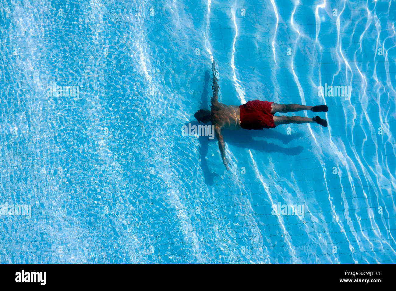 Top view of a man in swimming pool Stock Photo - Alamy