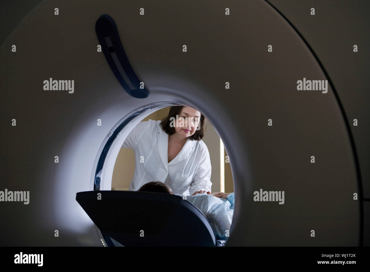 Female doctor examining patient before CT scan Stock Photo - Alamy