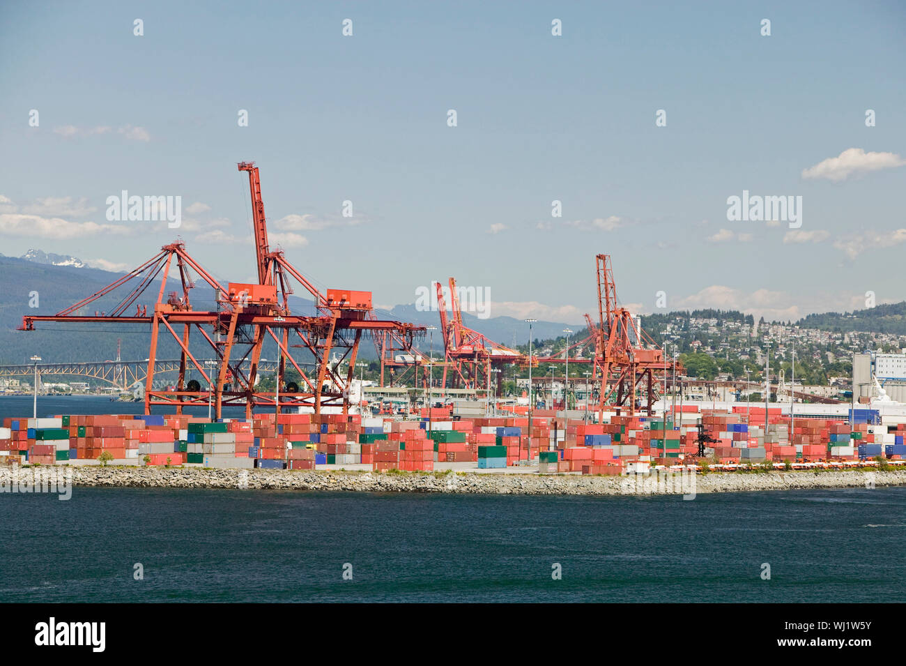 Cargo freight ship with working crane in shipyard at harbour Stock ...