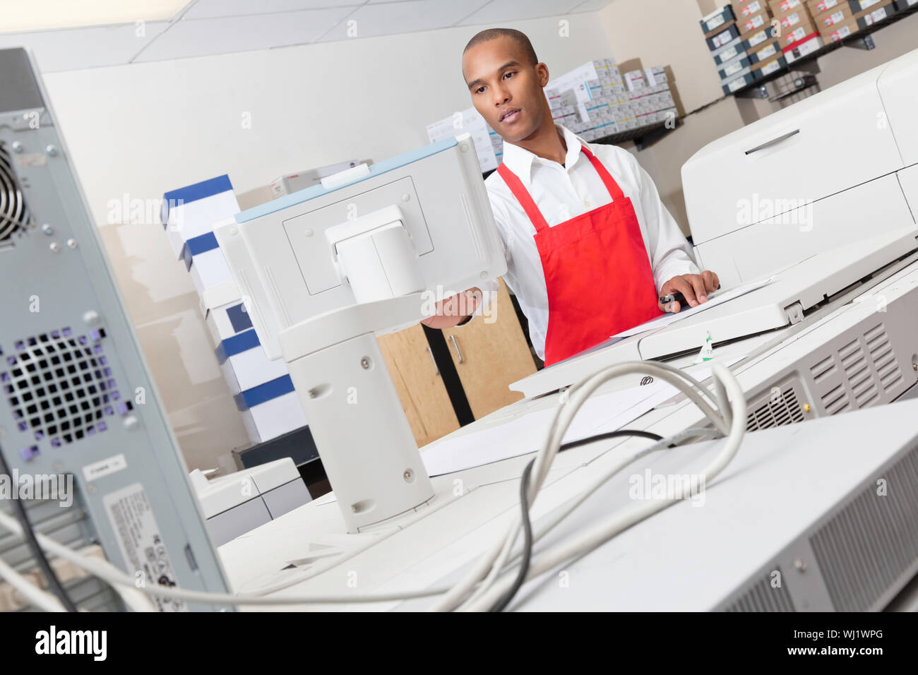 Man operating printing machine at press Stock Photo - Alamy