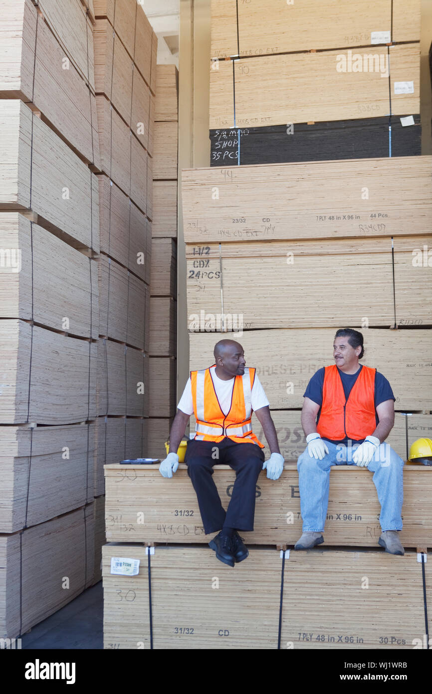 Men taking break from work in warehouse Stock Photo - Alamy