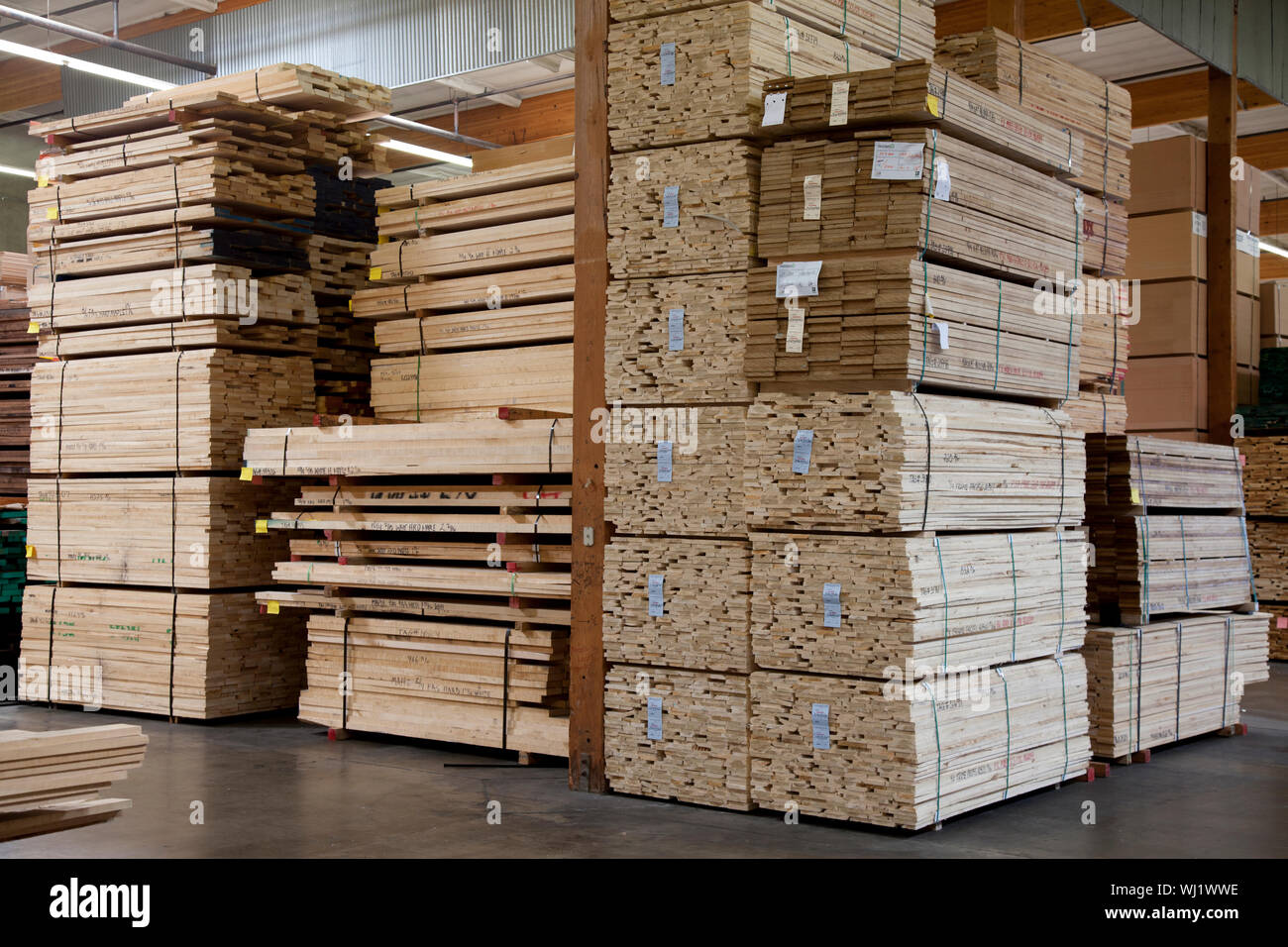 Stacks of plywood piled up in warehouse Stock Photo - Alamy