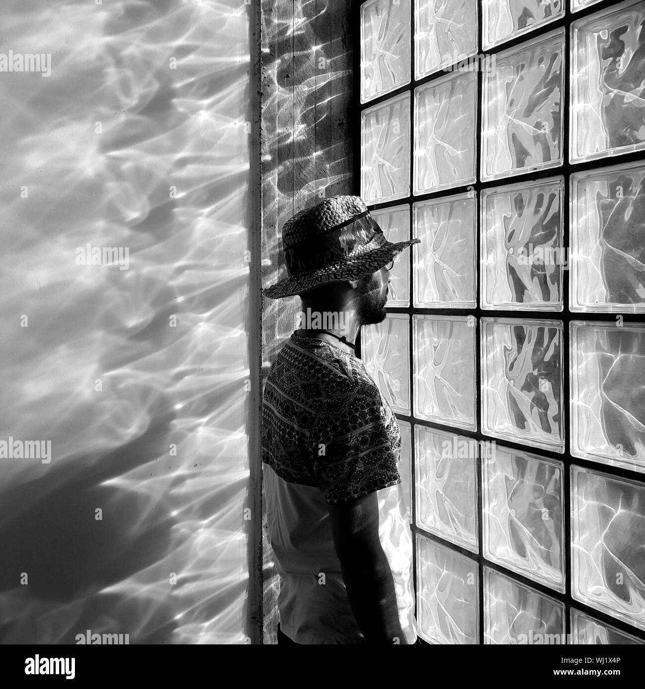 Man looking through window Black and White Stock Photos & Images - Alamy
