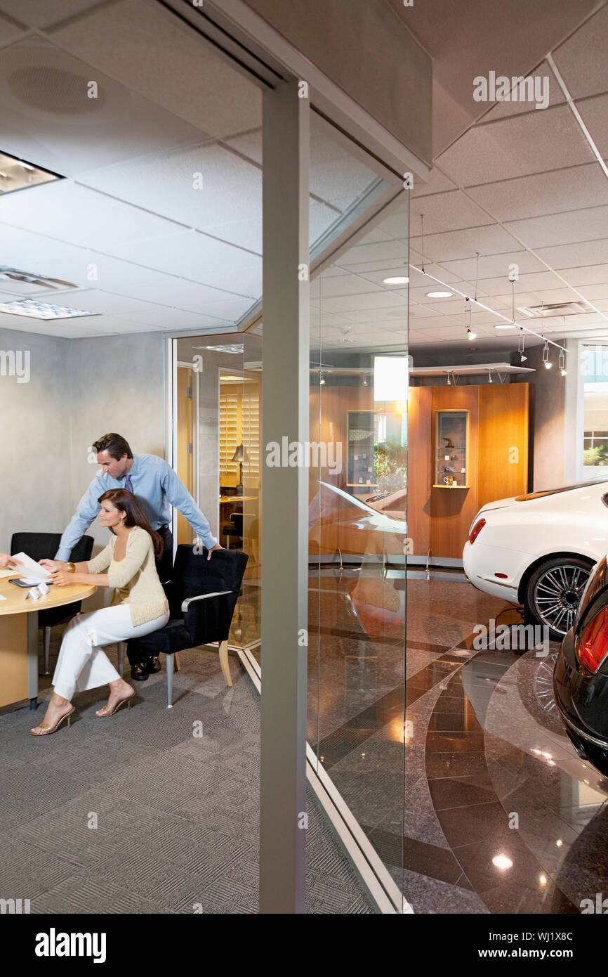 Woman signing contract of her new car Stock Photo - Alamy