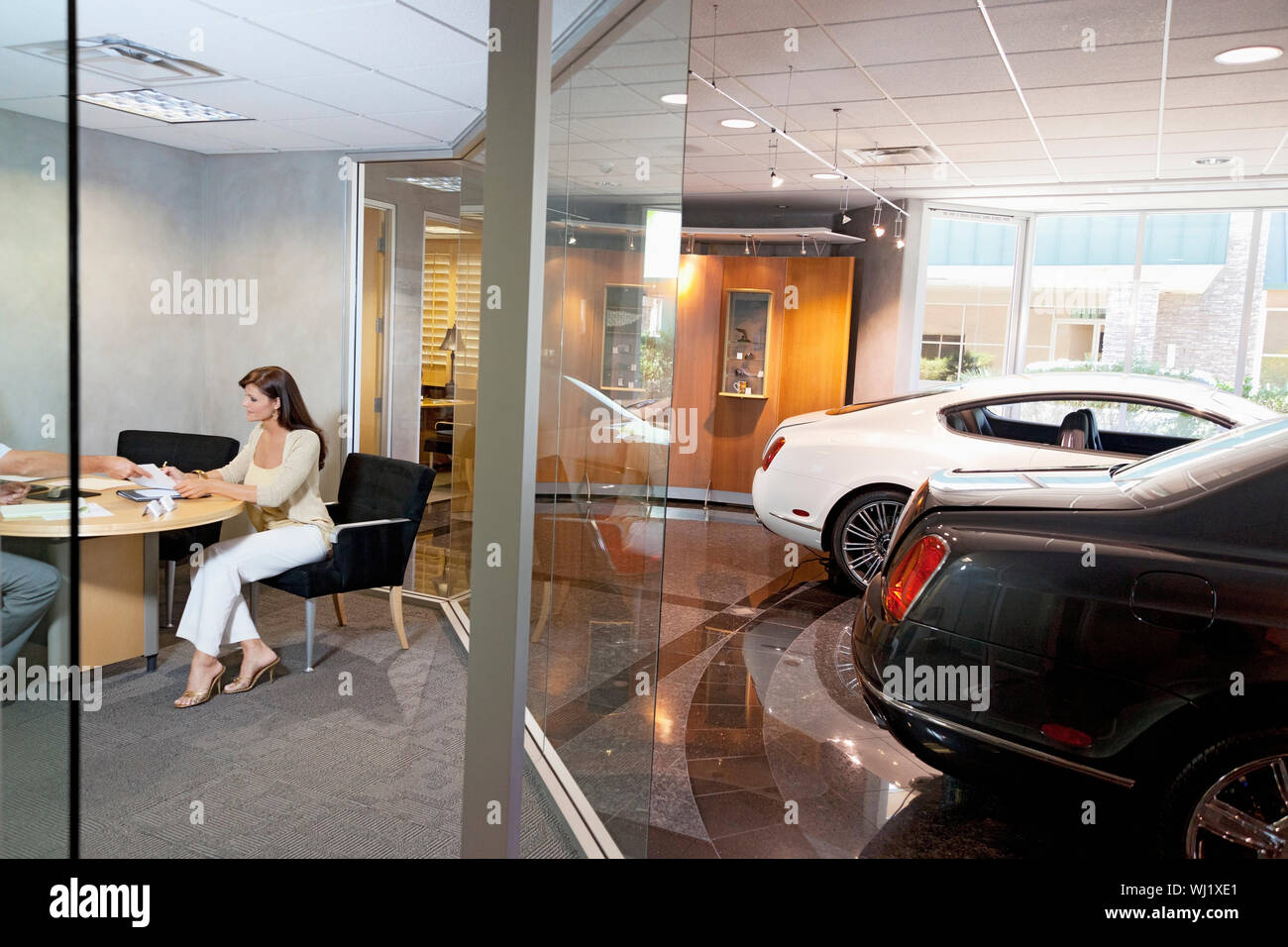 Signing papers at dealership hi-res stock photography and images - Alamy