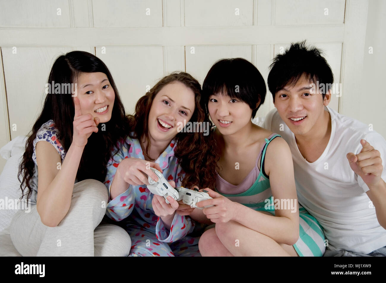 Friends playing video game Stock Photo - Alamy