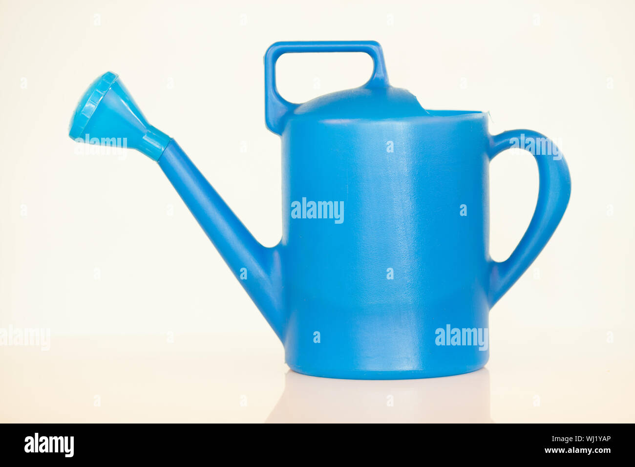Blue watering cans hi-res stock photography and images - Alamy