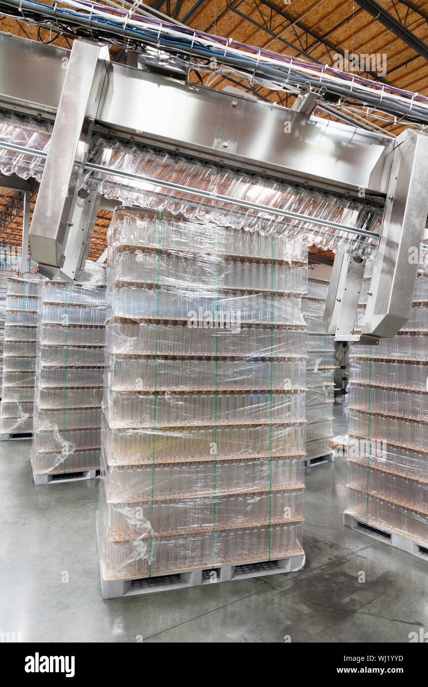 Stack of bottled water kept in warehouse Stock Photo - Alamy