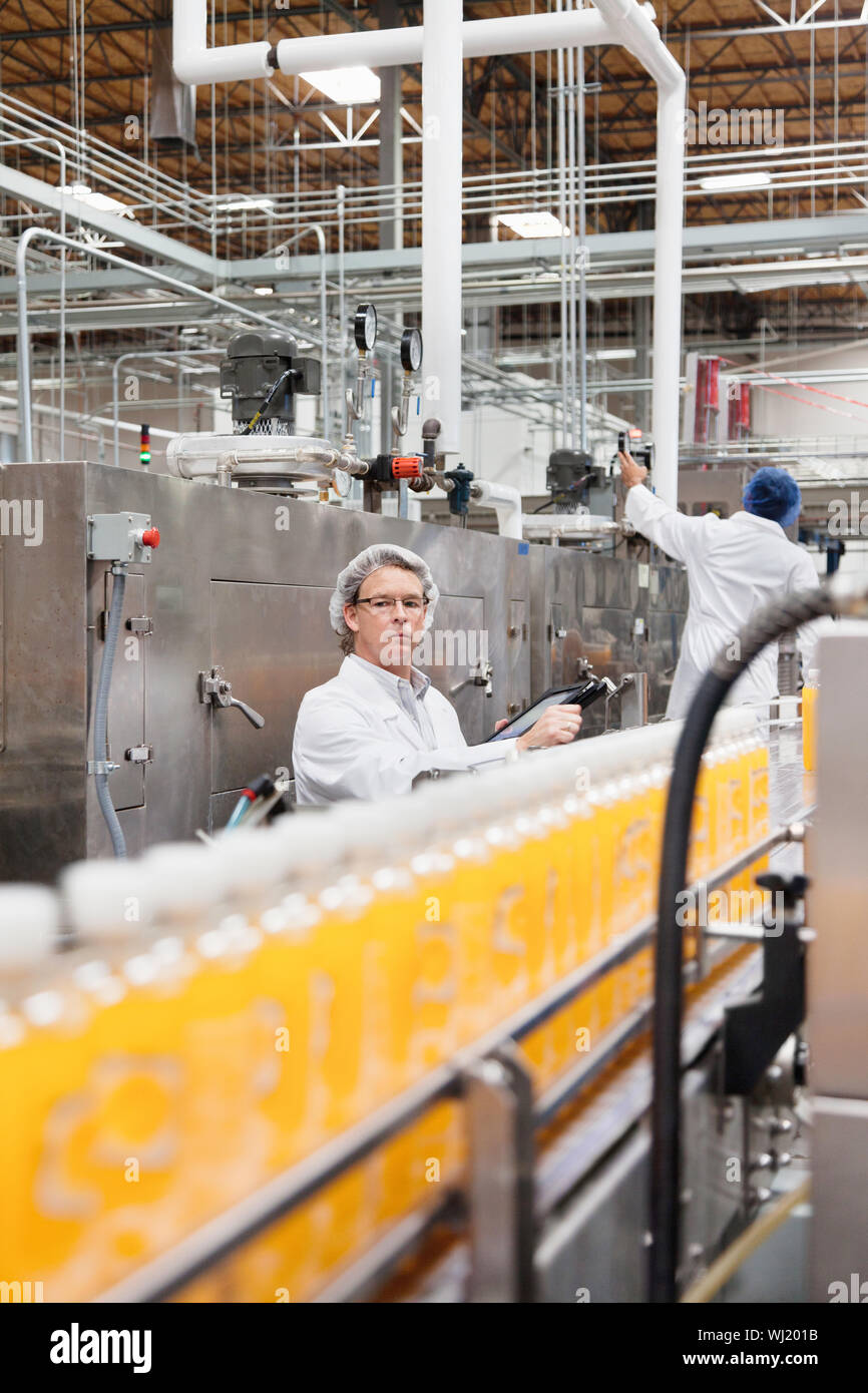 Group of men working at a production line hi-res stock photography and ...