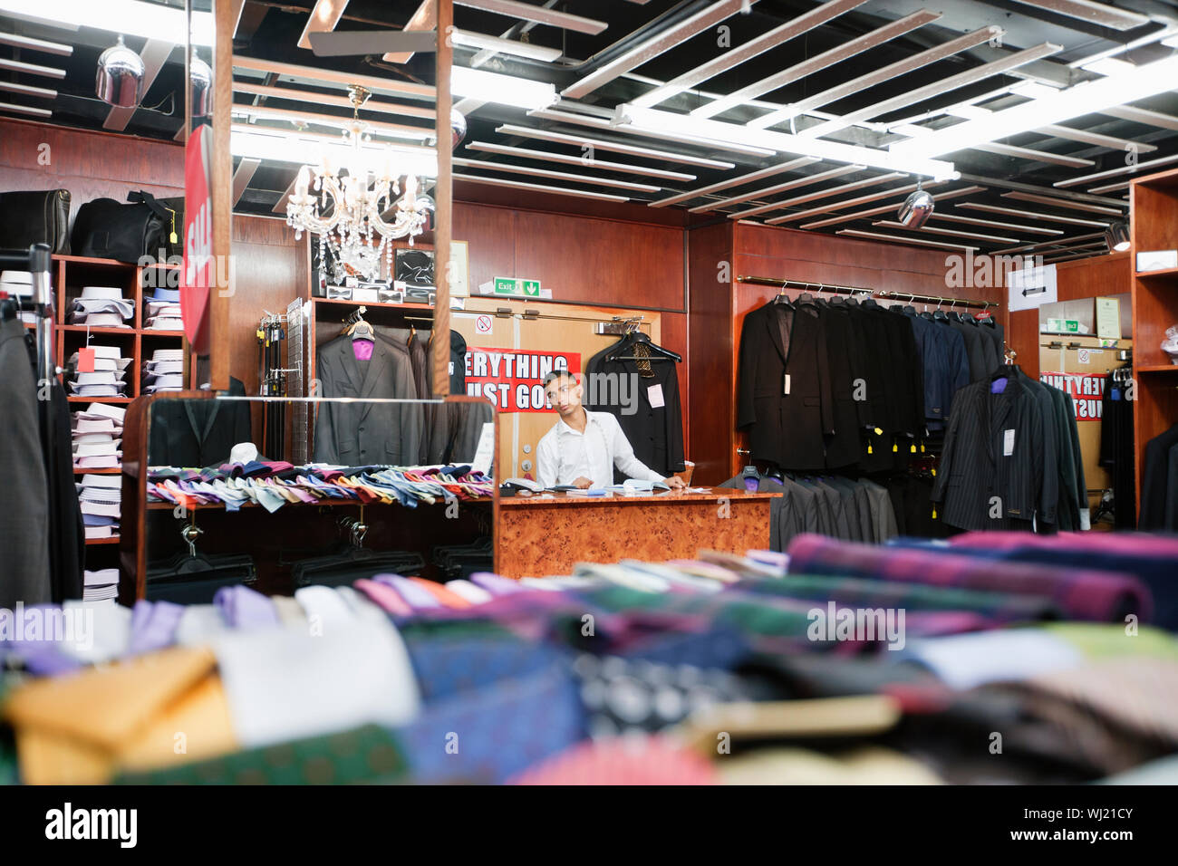 Man working in a clothing store Stock Photo - Alamy
